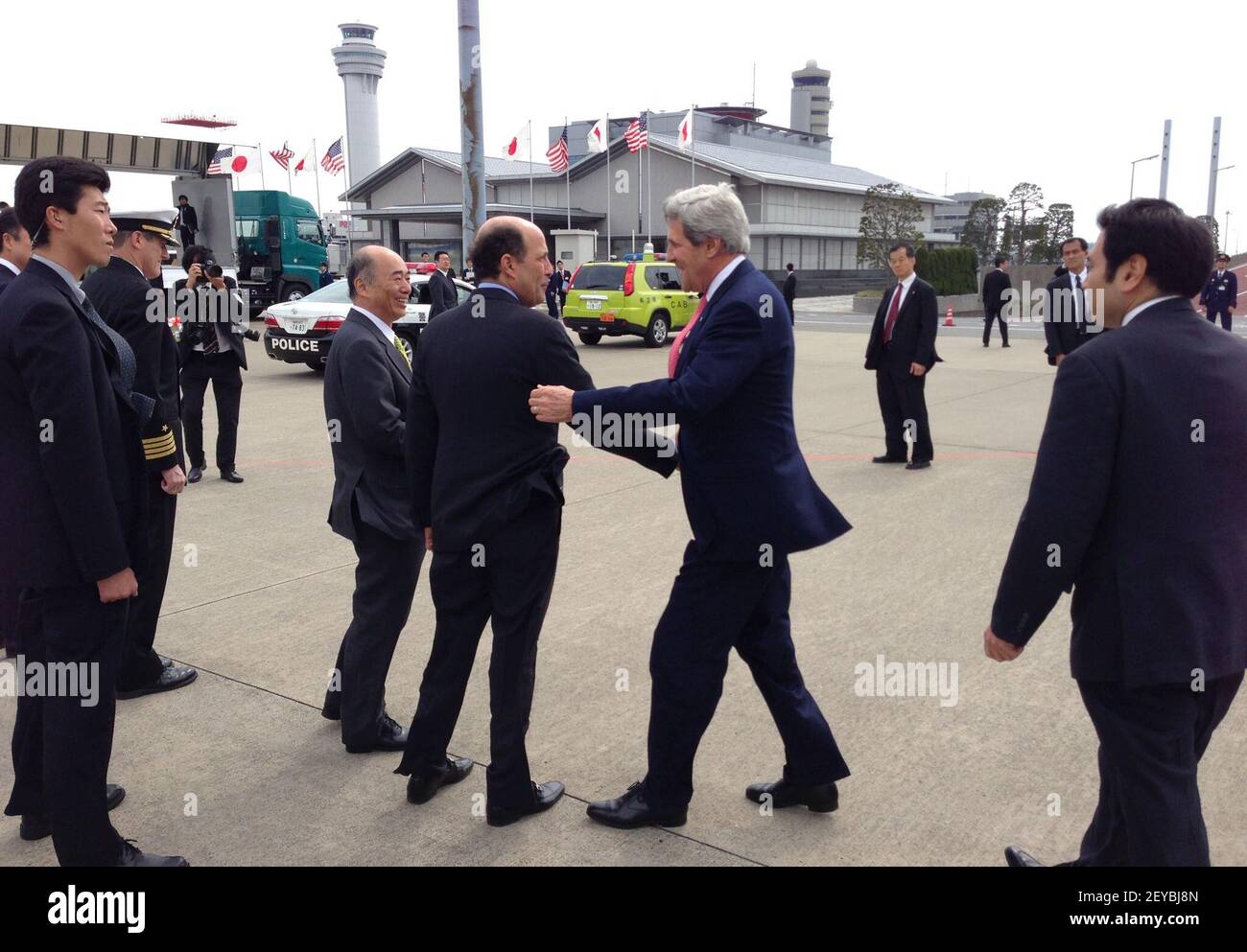 U.S. Secretary of State John Kerry is greeted by John Roos, the U.S ...