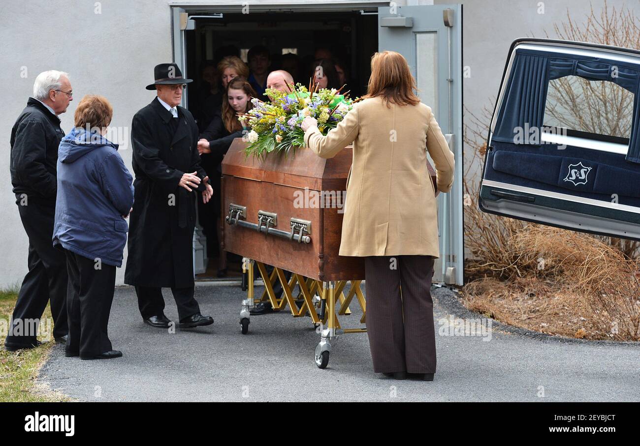 Friends and family roll Ron Marshall's hand-crafted casket into a ...