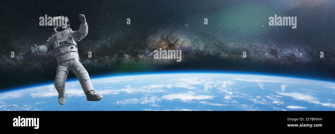 astronaut during a spacewalk in orbit of planet Earth, background ...