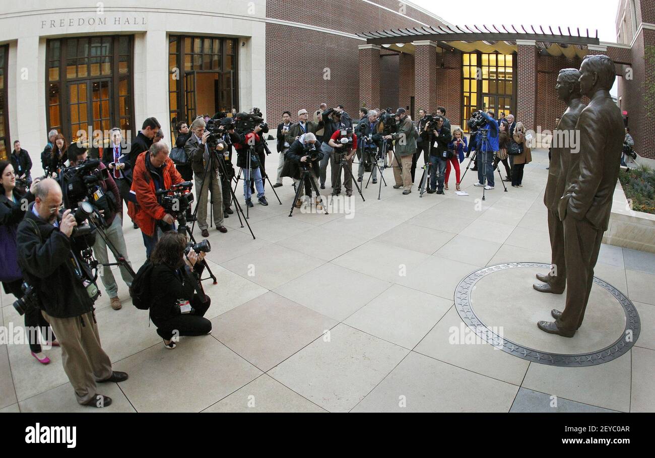 News media members surround the two bronze statues of former United ...