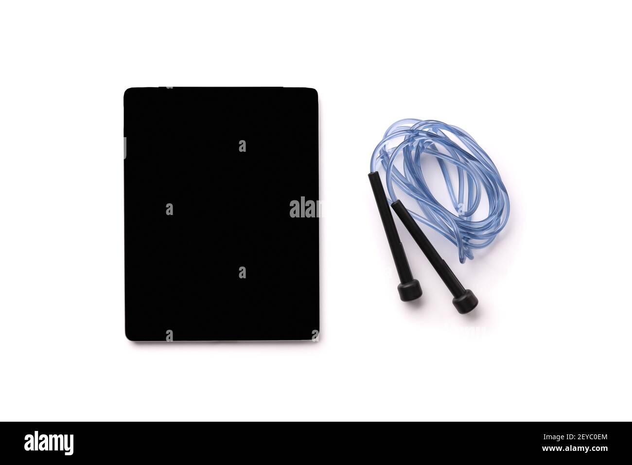 Flat lay top view jump rope and tablet with empty screen on white ...