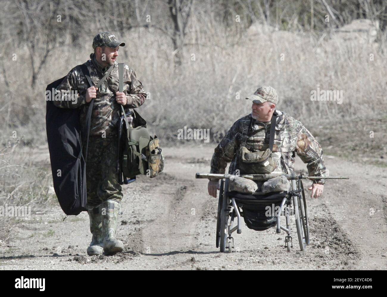 Brian Lewellen, left, hauls gear for disabled firefighter Roger Dakin ...