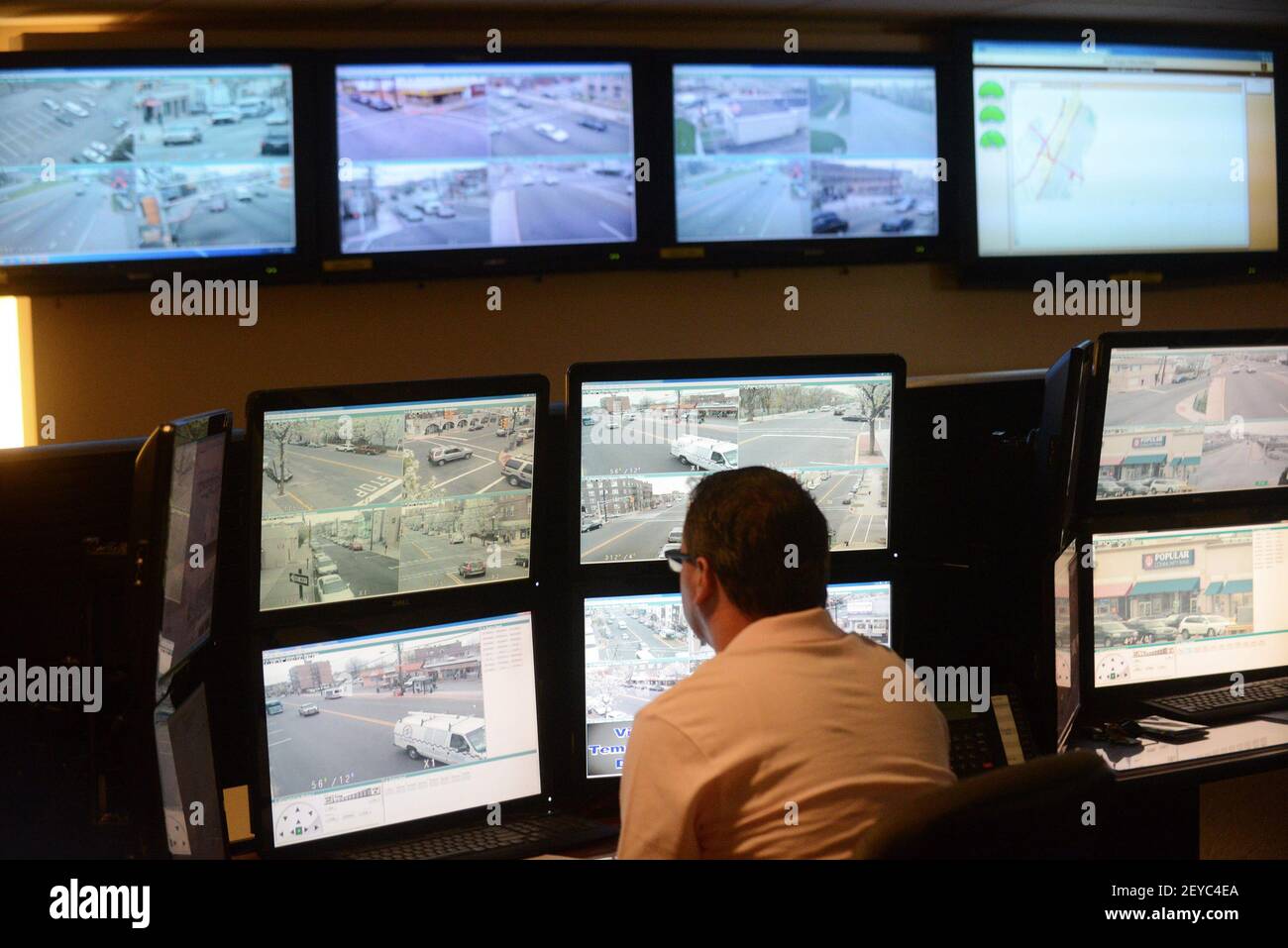 Retired police detective Robert Scudieri watches monitors with video ...