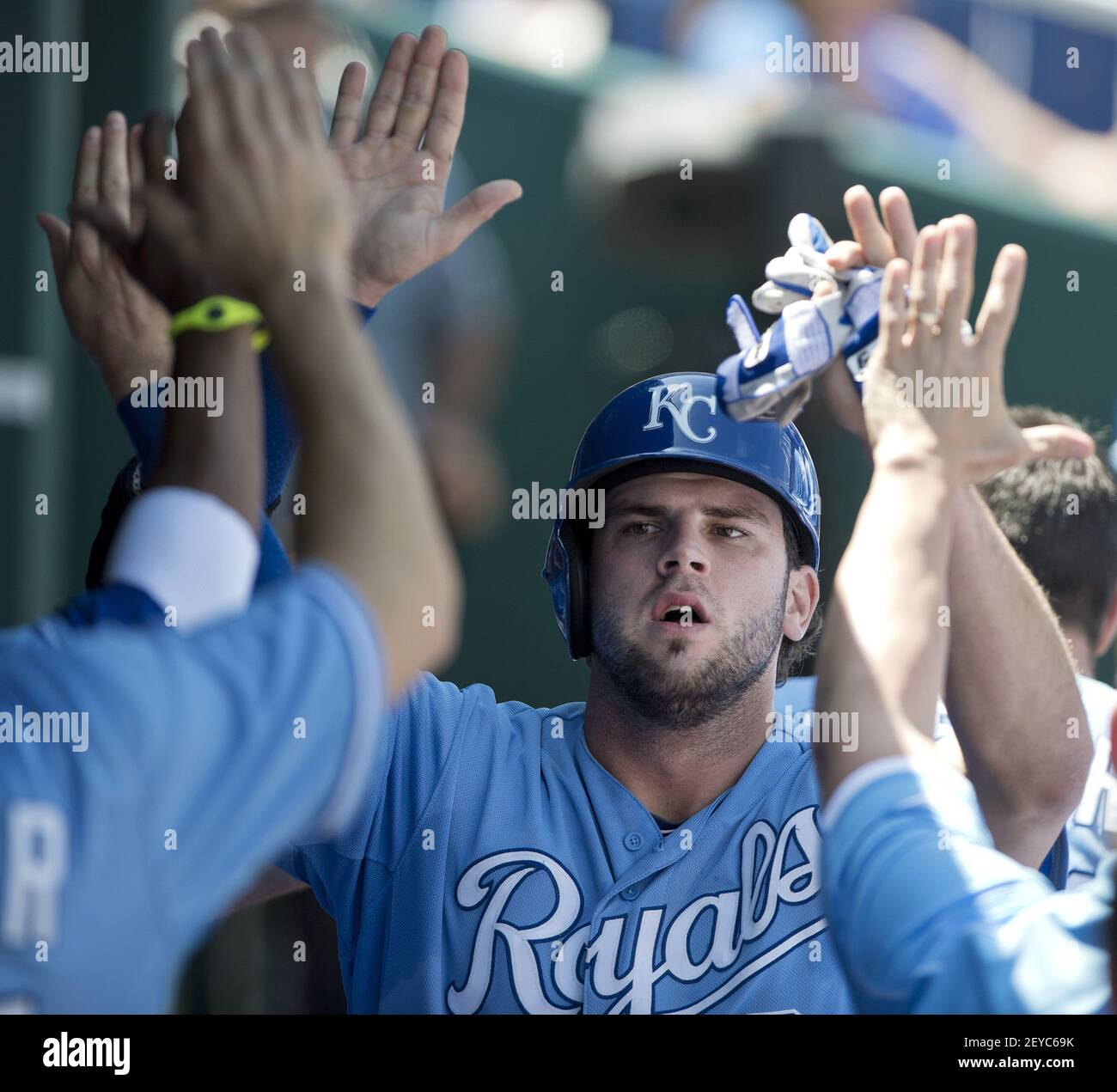 Kansas City Royals' Mike Moustakas is congratulated after scoring on a ...