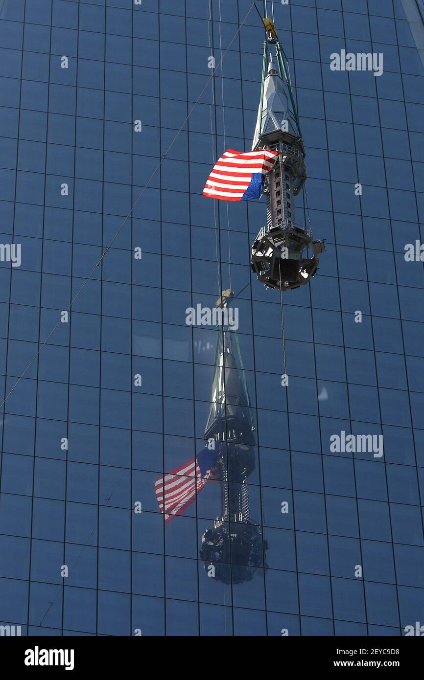 Reflected in the glass facade of One World Trade Center , he final 408 ...