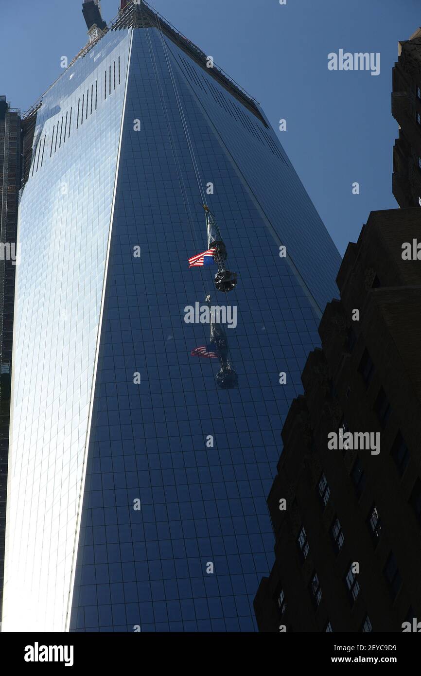 Reflected in the glass facade of One World Trade Center , he final 408 ...