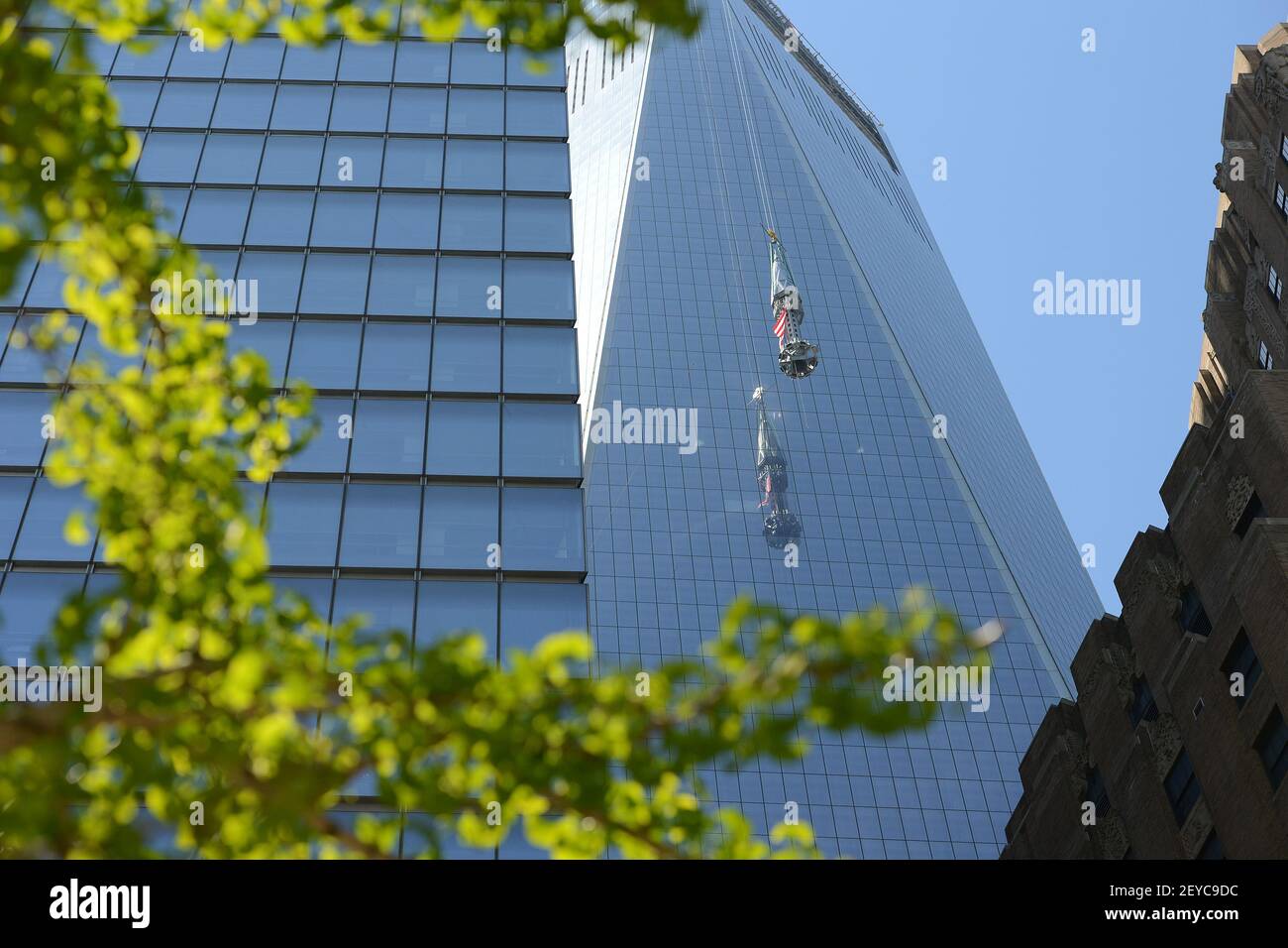 Reflected in the glass facade of One World Trade Center , he final 408 ...