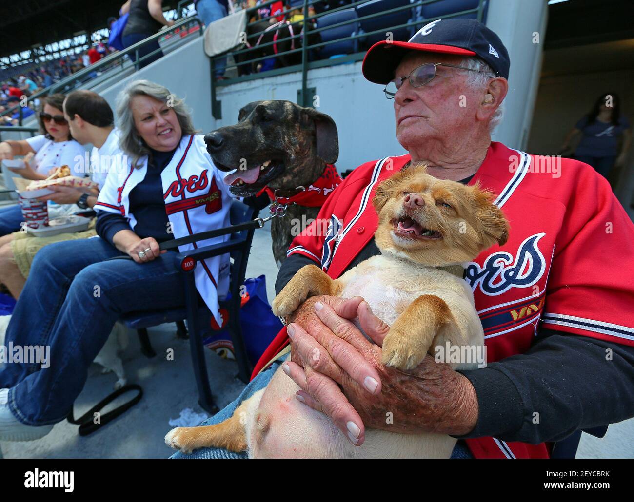 George Lavery holds his dog, Chipper, named after Chipper Jones, while ...