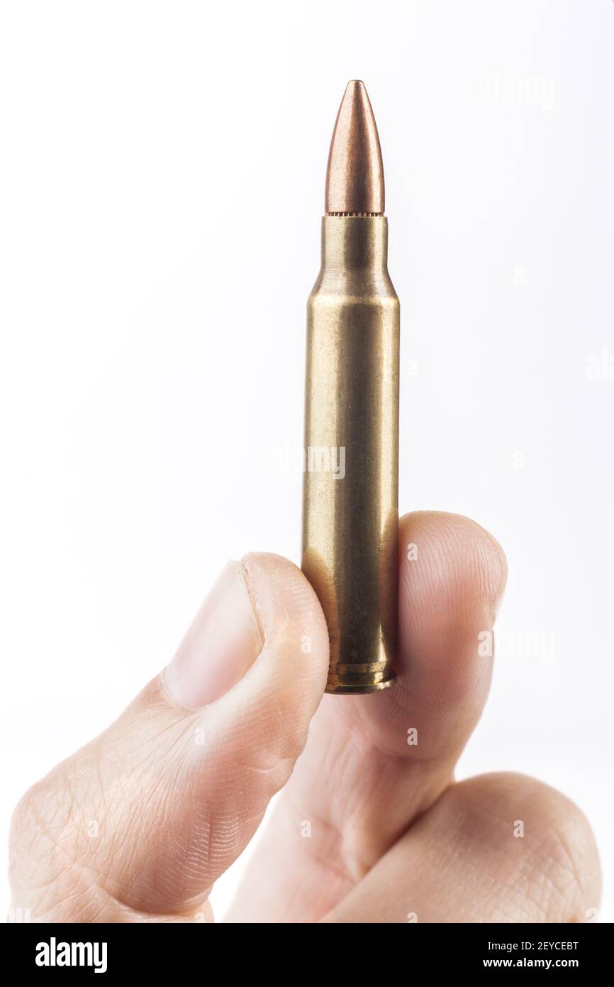 Finger Holding Up Bullet Stock Photo - Alamy