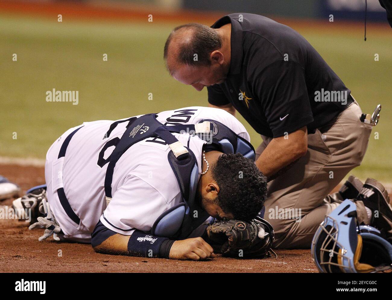 Tampa Bay Rays athletic trainer Ron Porterfield tends to catcher Jose ...