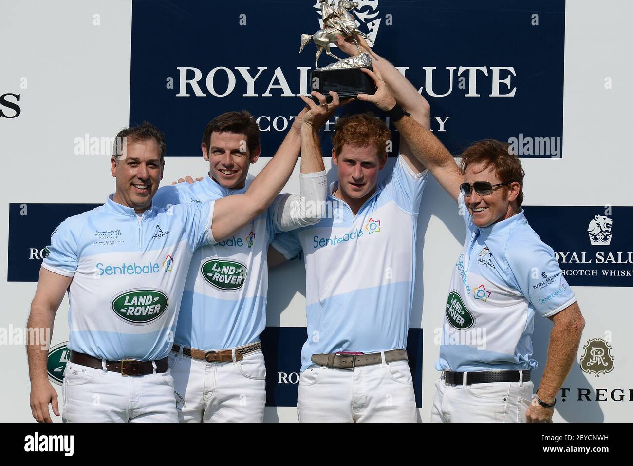 Prince Harry (center) poses with trophy and Marc Ganzi, Malcom Borwick ...