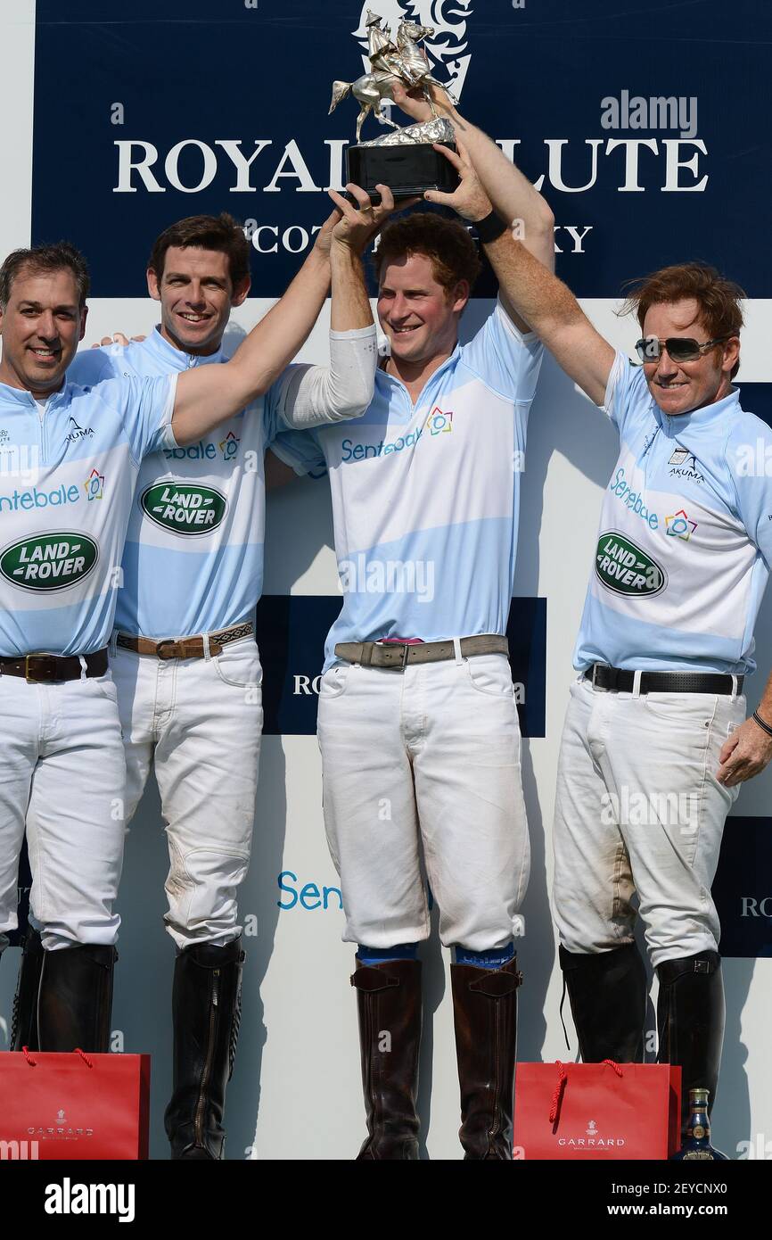 Prince Harry (center) poses with trophy and Marc Ganzi, Malcom Borwick ...