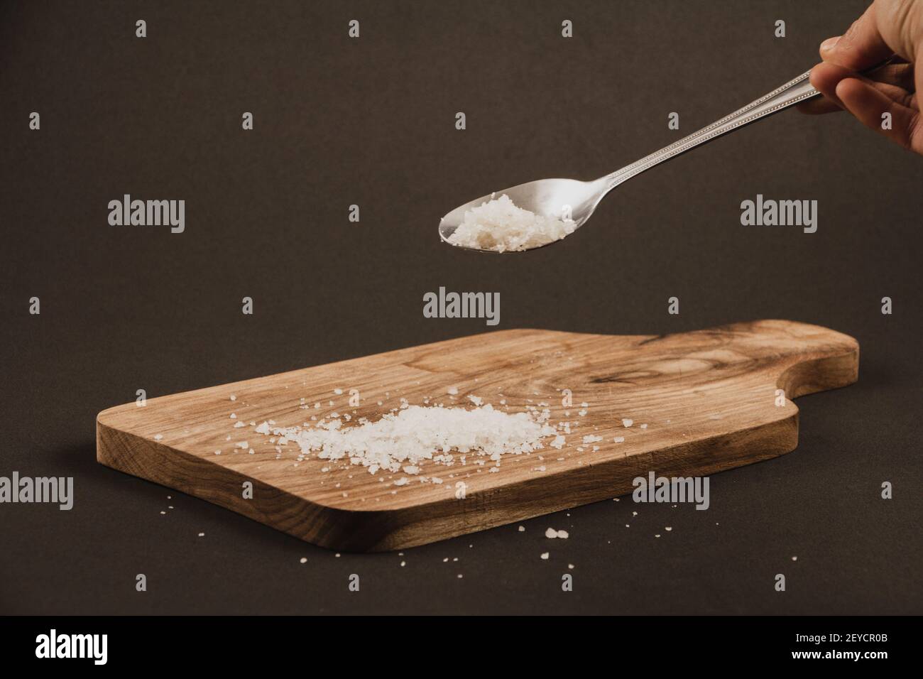 Top view of Salt or sea salt in a wooden bowl on a aged wooden table ...