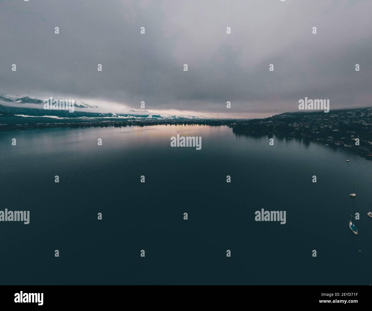 An amazing aeral shot of the calm river with boats and ships against ...