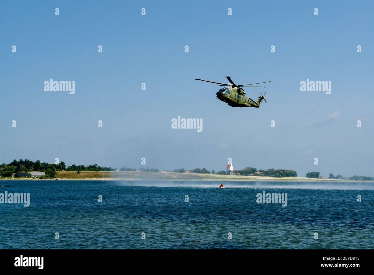 A diver connected to a helicopter with a rope in the process of diving ...