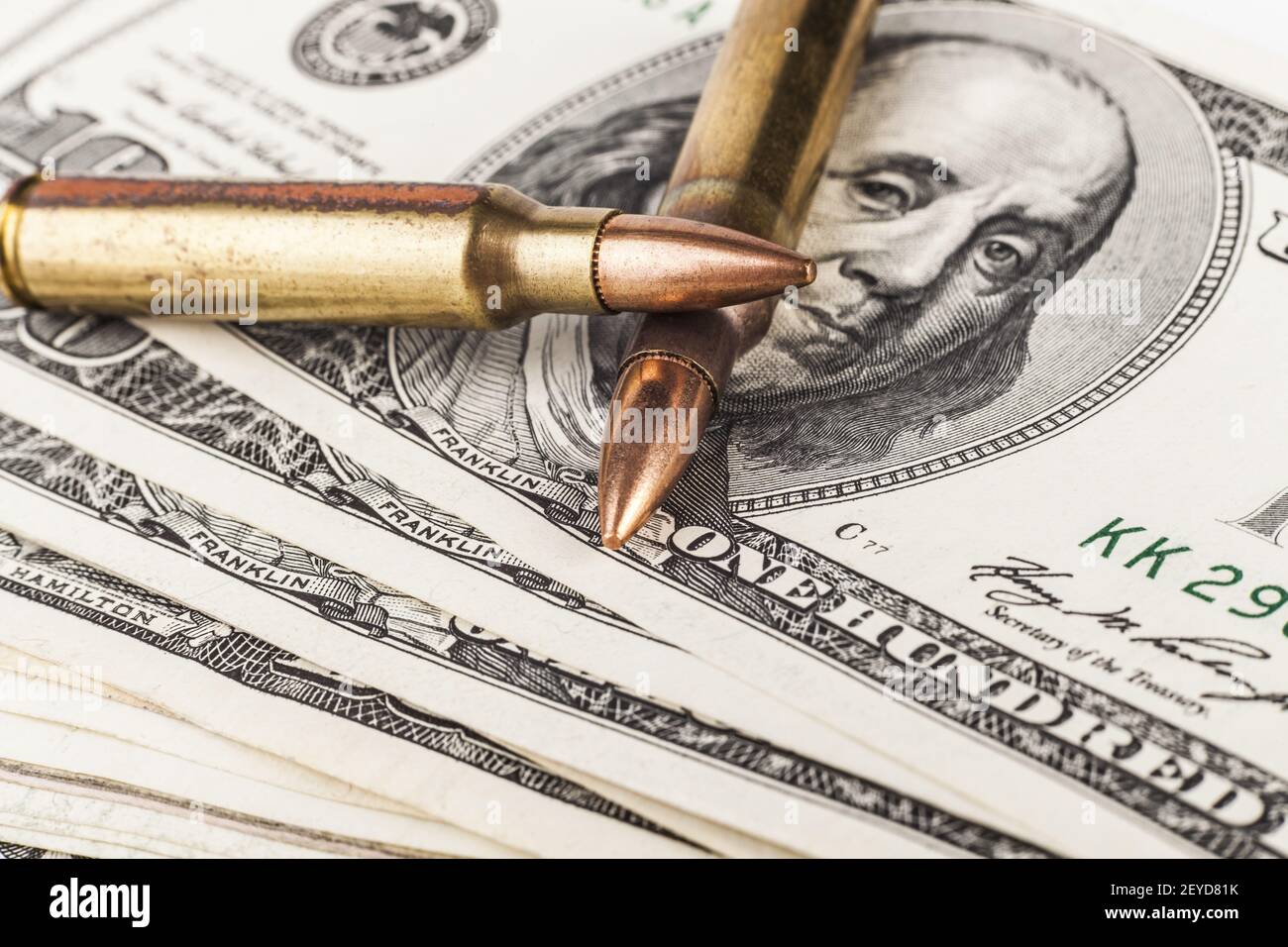 Two Bullets on Dollars Stock Photo - Alamy