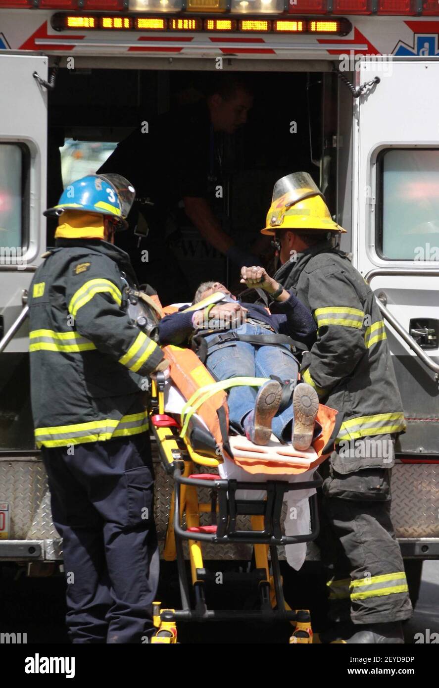 An injured person is placed in an ambulance after being taken from the ...