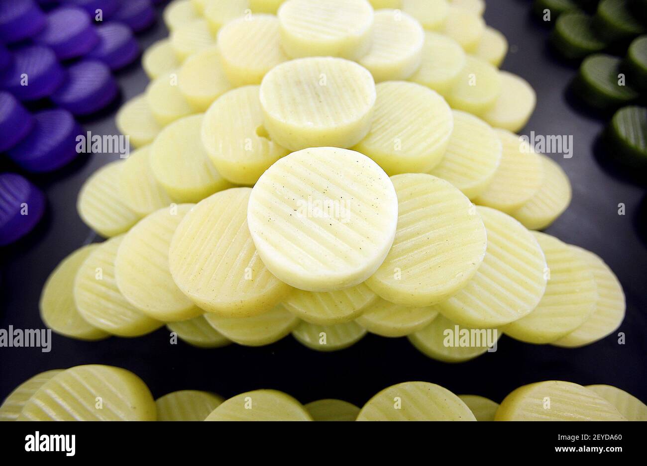 Freshly cut soaps are stacked and ready to be wrapped at JustNeem, a ...