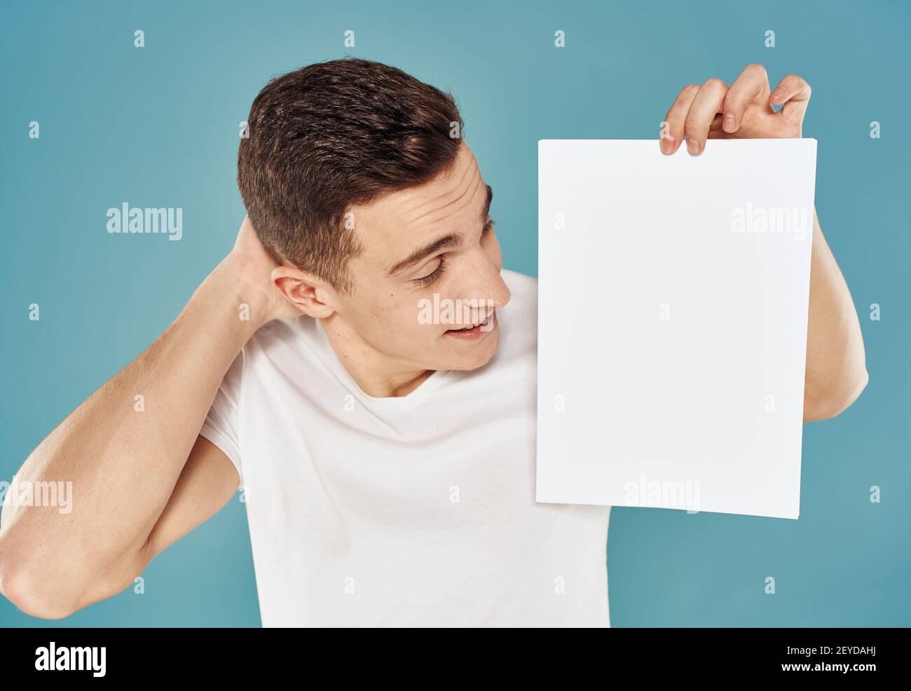 man with flyer in hand and mockup blue background cropped view Stock ...