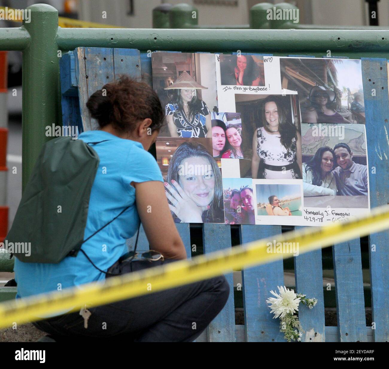 An unidentified woman kneels by a memorial for Kimberly Finnegan ...