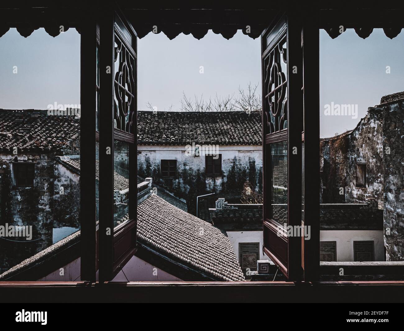Old-styled vintage open windows with a view of old town ancient ...