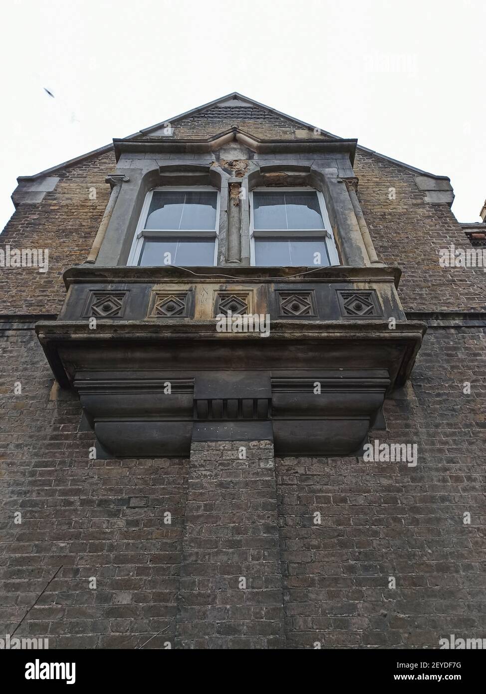 A vertical low angle shot of a beautifully architectured ancient stone ...