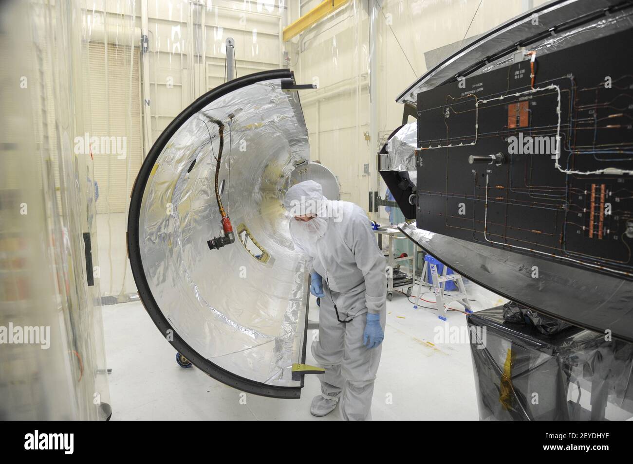 Orbital Sciences team members move the second half of the payload ...
