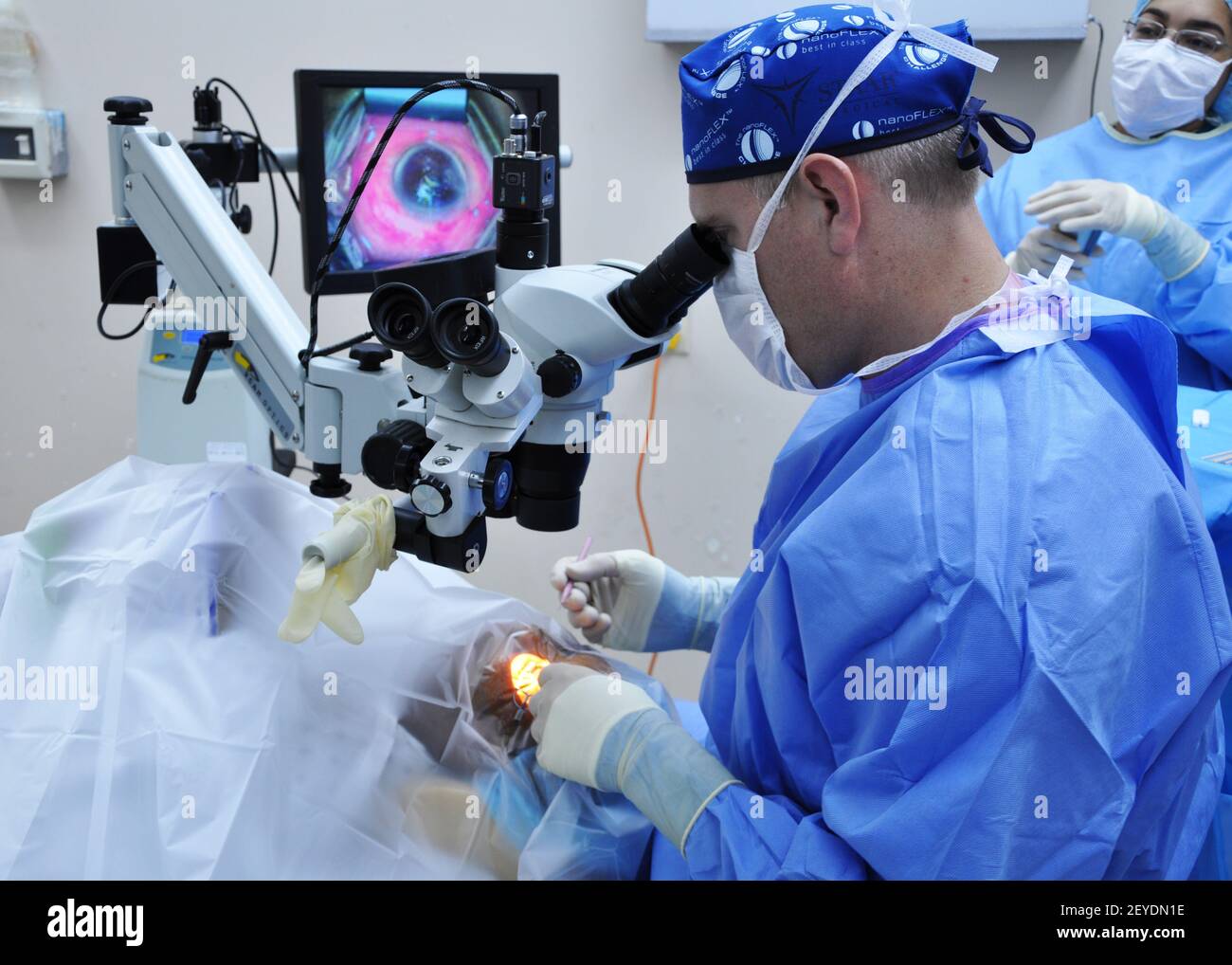 U.S. Air Force Maj. Matthew Caldwell, foreground right, a cornea and ...