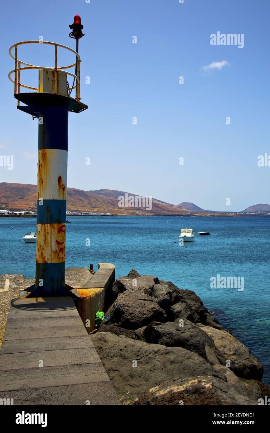 Spain lighthouse and harbor pier boat in the Stock Photo - Alamy