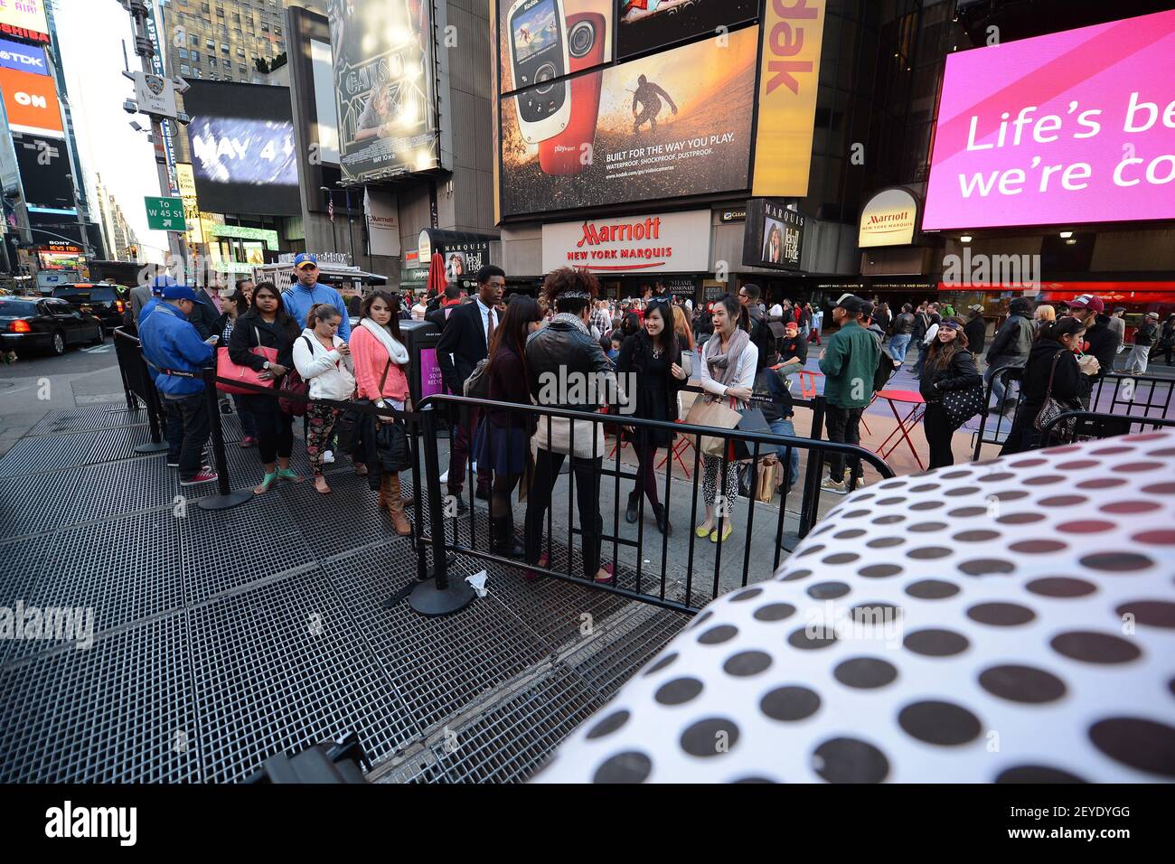 A long line of people wait to have their portrait taken inside a mobile ...