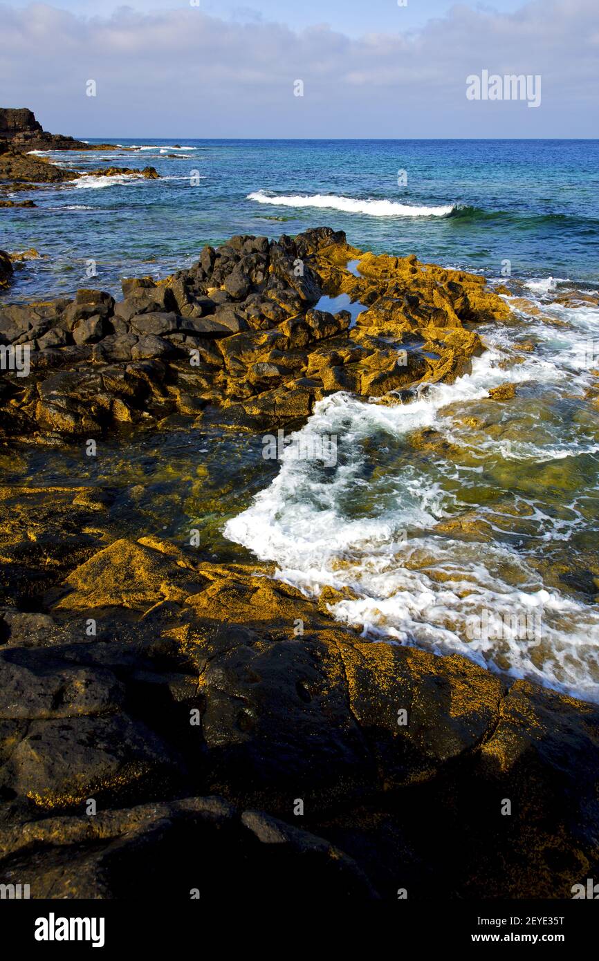 Beach light foam rock stone sky cloud Stock Photo - Alamy
