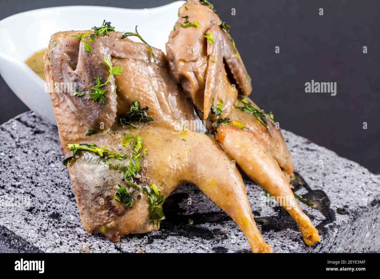 Quail with green and purple salad on grey stone, wood table Stock Photo ...
