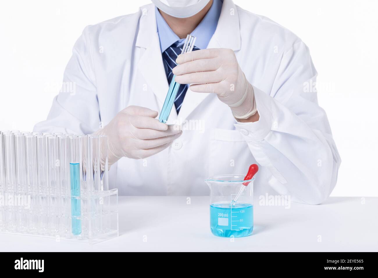 A closeup of a scientist experimenting with blue toxic substances in ...