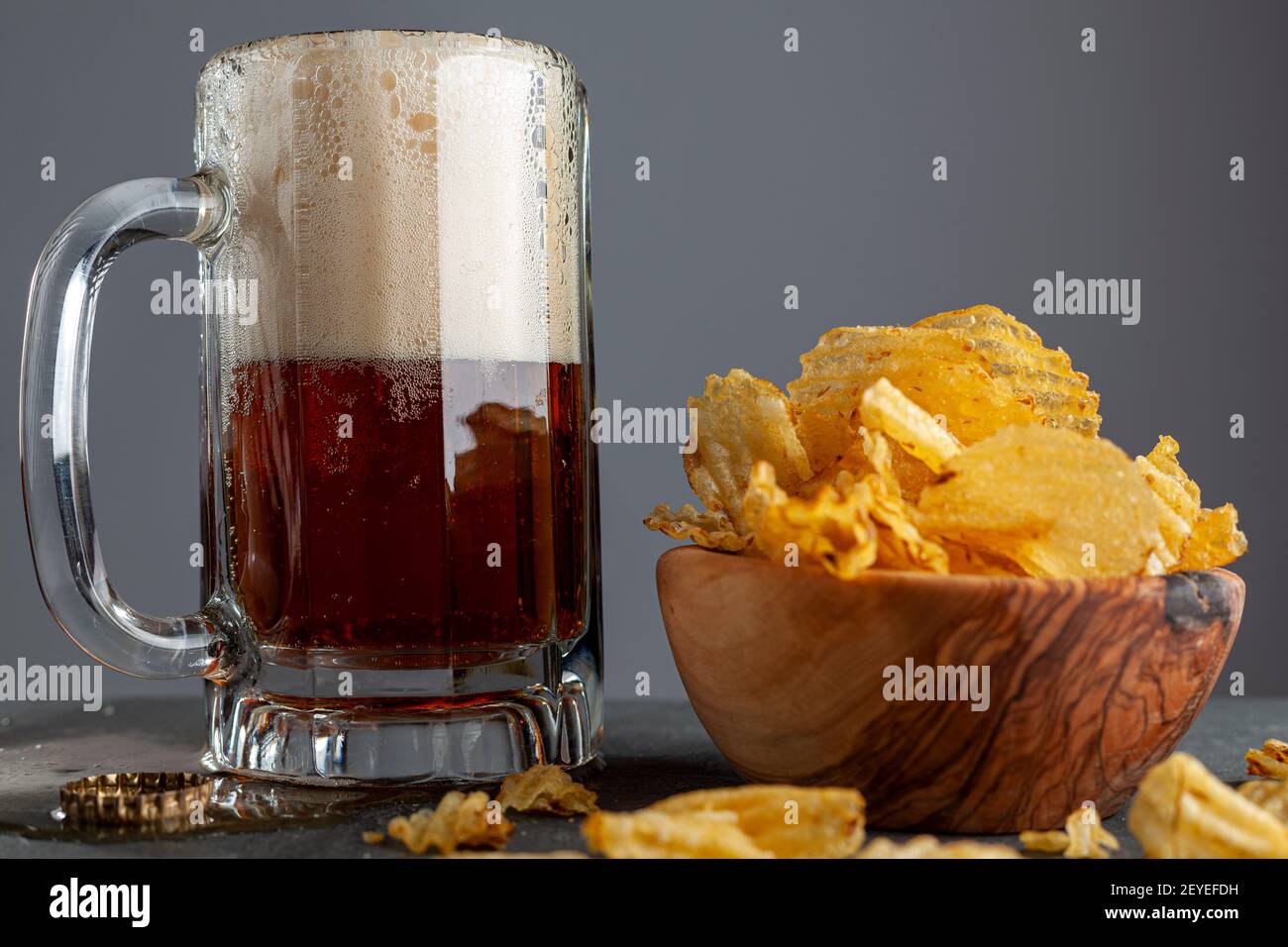 frothy craft beer in glass mug with handle in a pub with dark ...