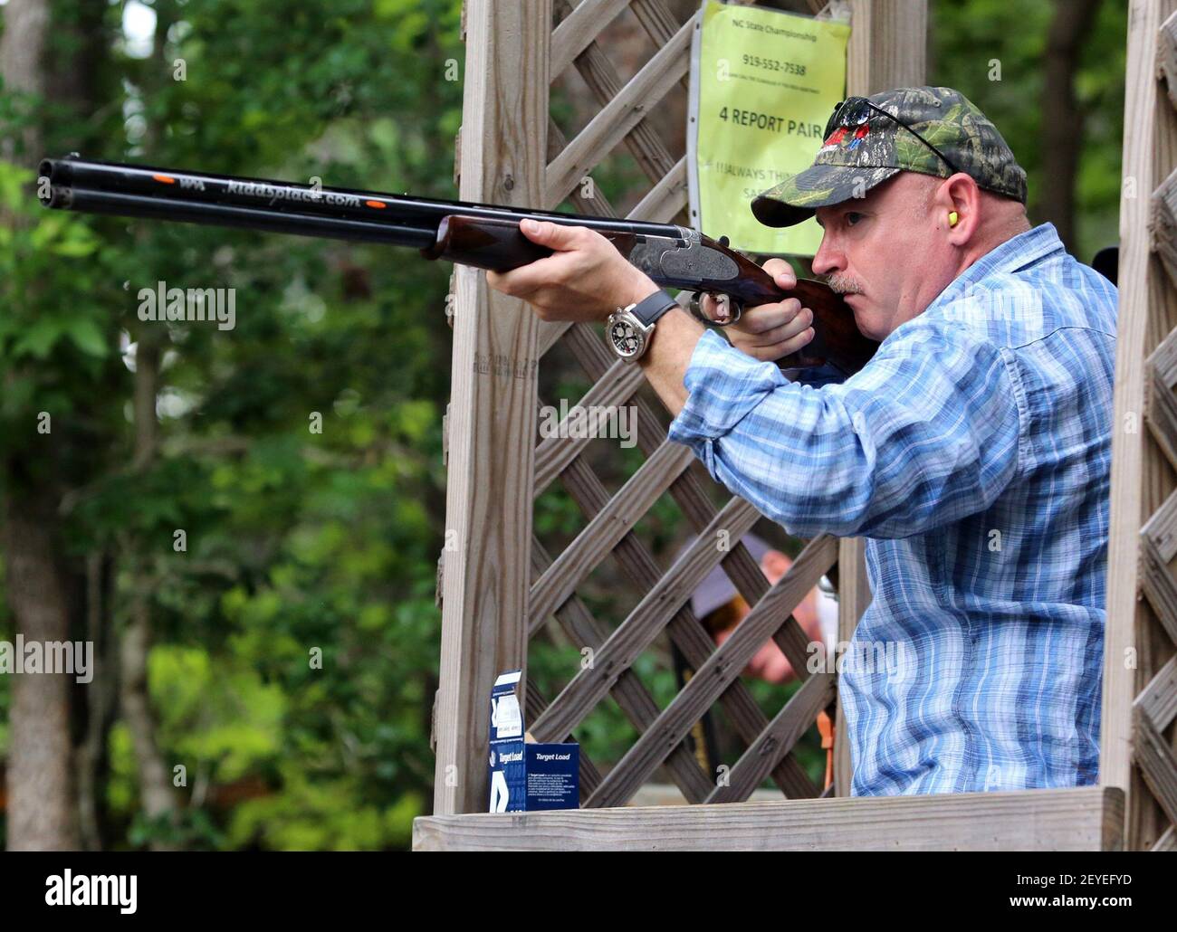 Mark Kelly shoots a clay disk with a shotgun at Kidds Place Sporting ...