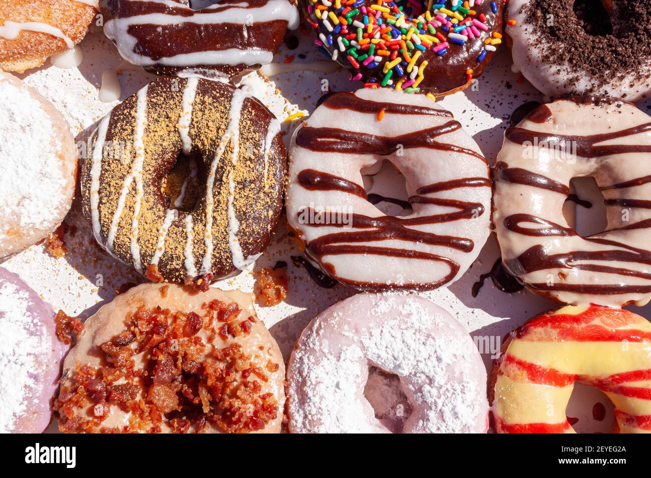 Closeup angled image of fresh made store bought donuts in paper box ...