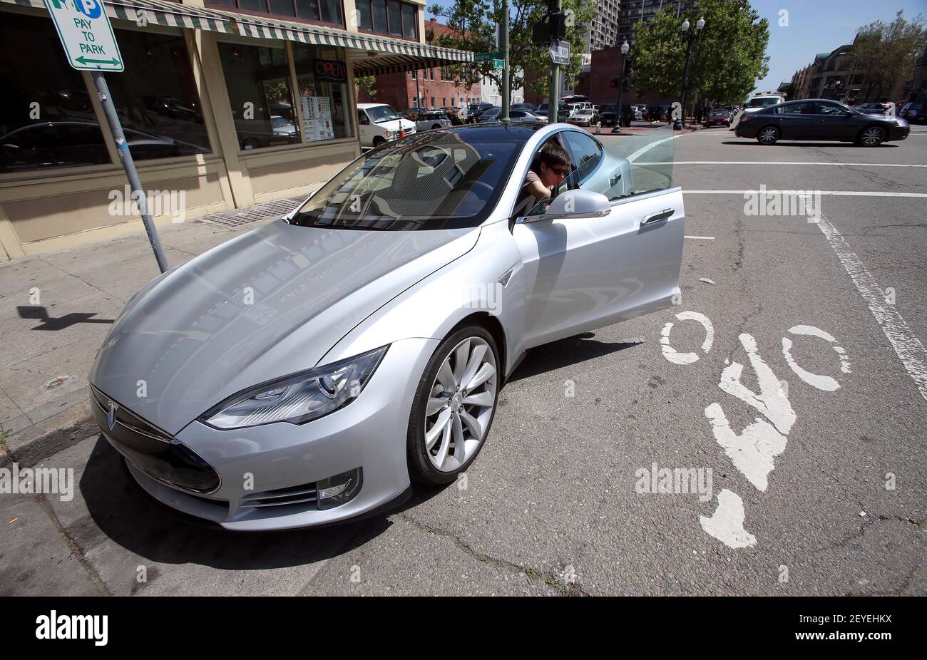 San Jose Mercury News reporter Dana Hull stops while taking a Tesla ...