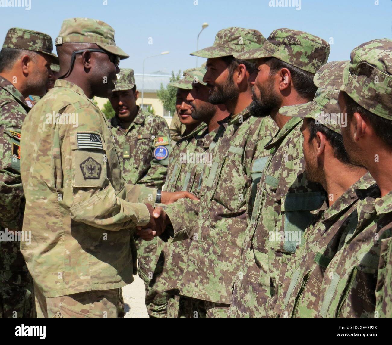 Maj. Dawud Agbere, left, talks with Afghan sholdiers at Camp Shaheen in ...