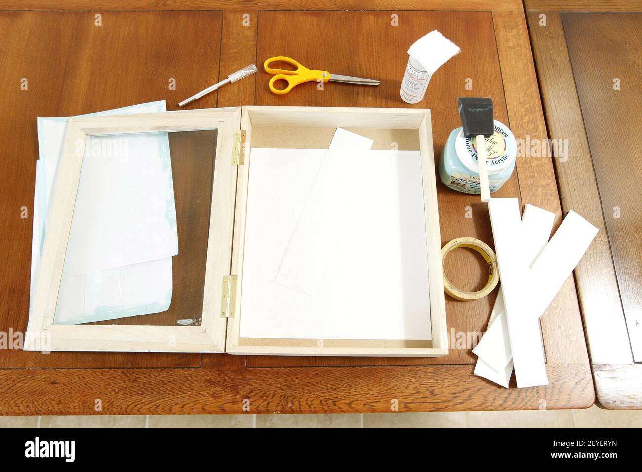 Supplies are gathered for DIY shadow boxes, which are simple wooden ...