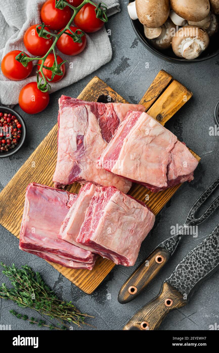 Raw Black Angus Marbled Beef Ribs set, with ingredients, on gray stone ...