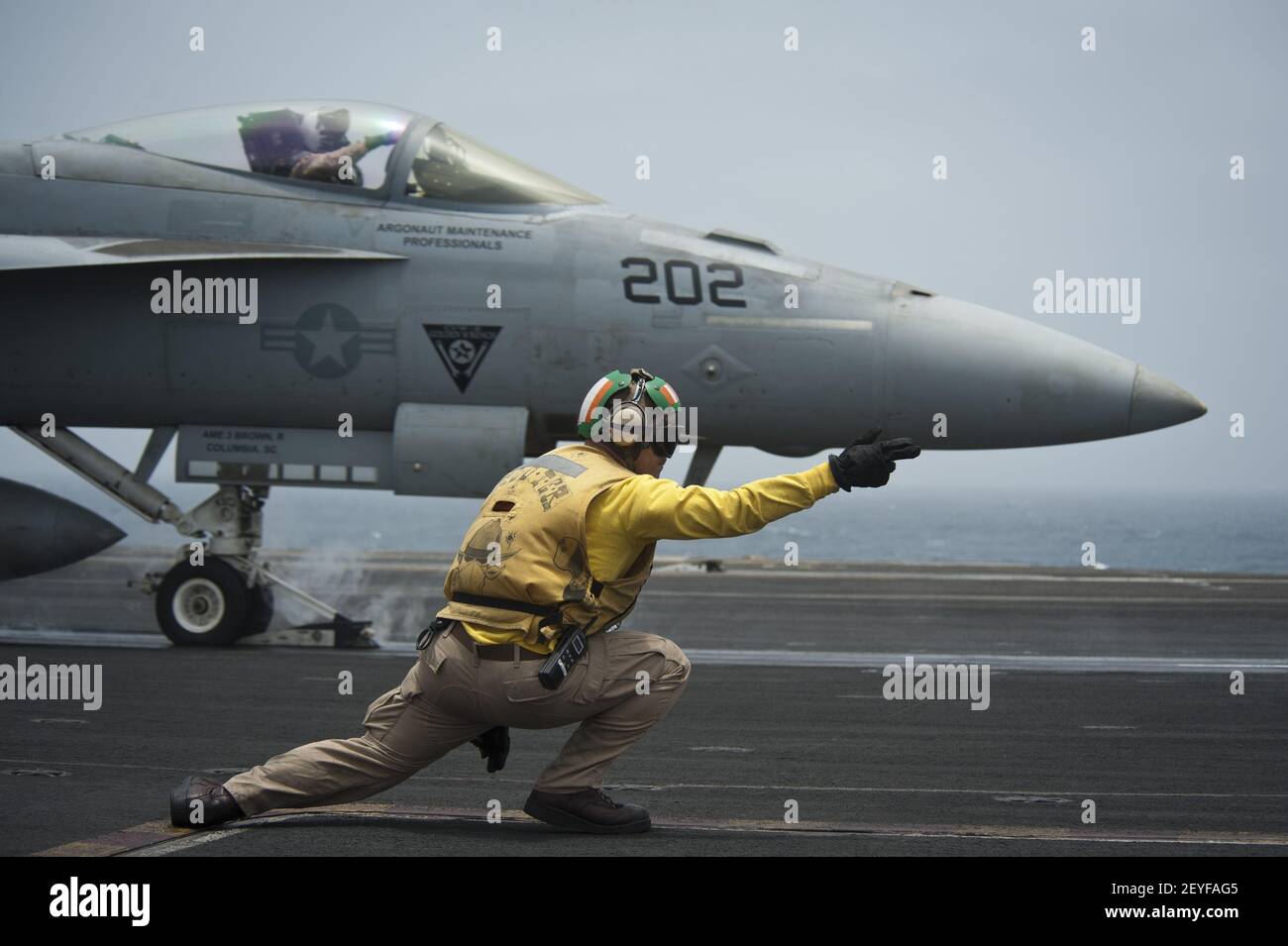 U.S. Navy Lt. Richard Dorsey signals for the launch an F/A-18E Super ...