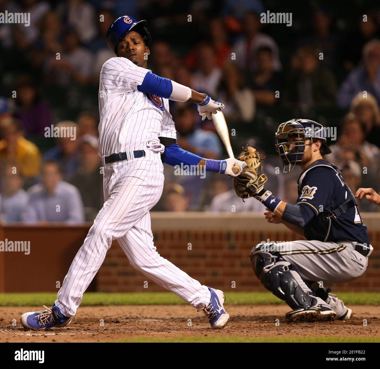 The Chicago Cubs' Junior Lake knocks his helmet off after missing a ...