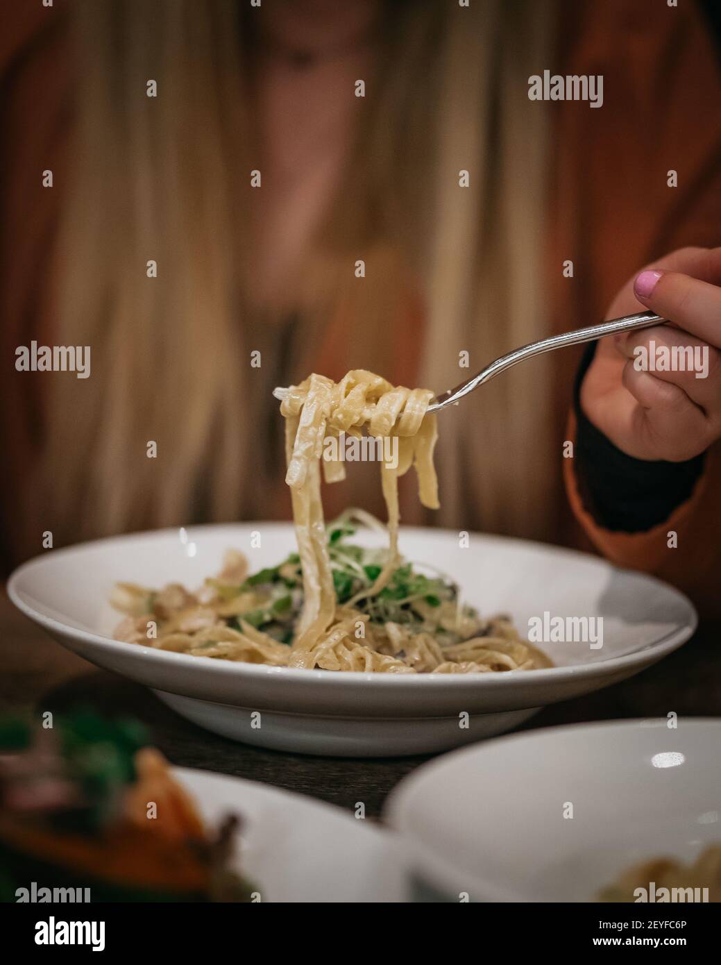 Woman eating pasta lunch restaurant hi-res stock photography and images ...