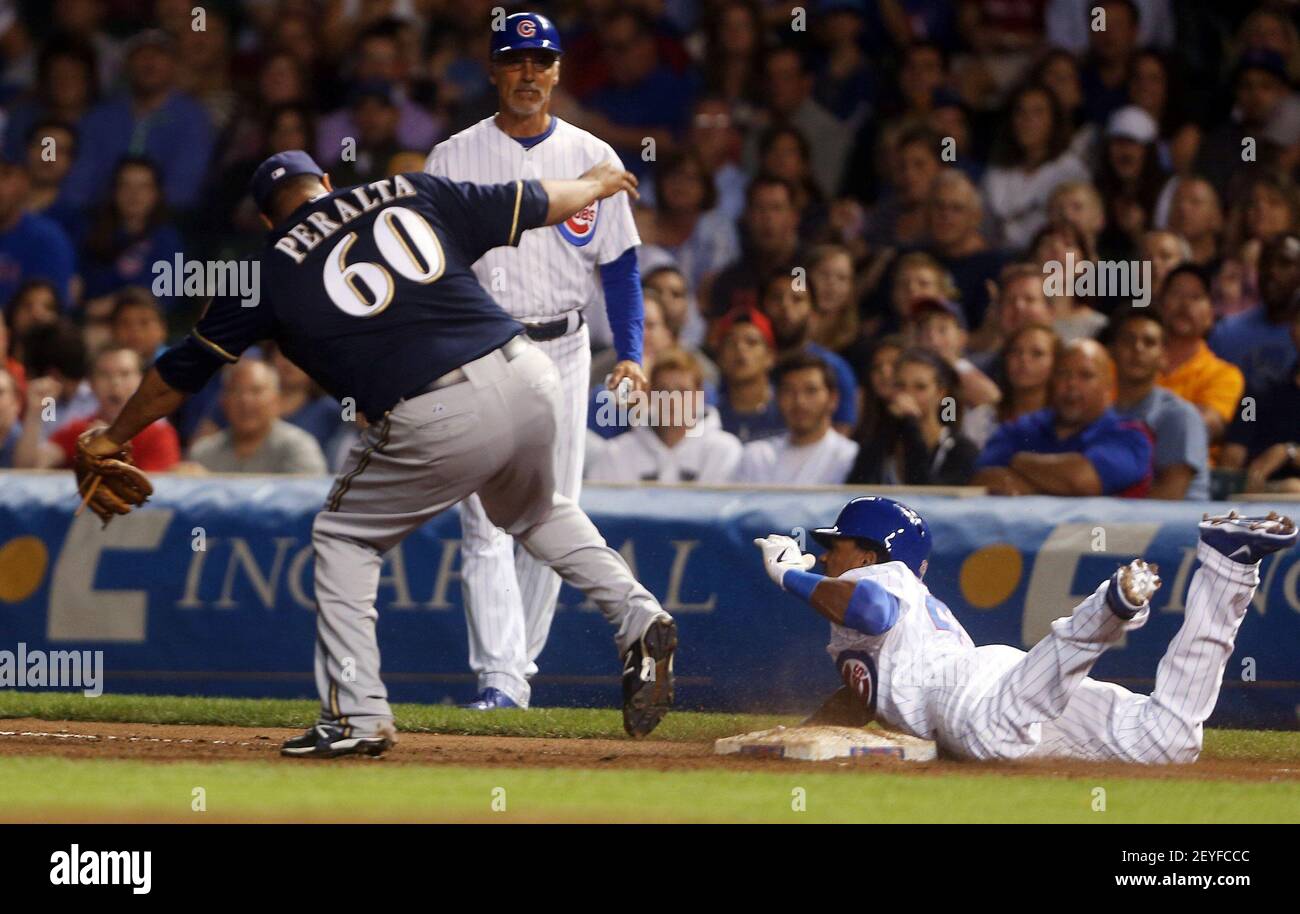 The Chicago Cubs' Julio Borbon, right, dives into first base ahead of ...