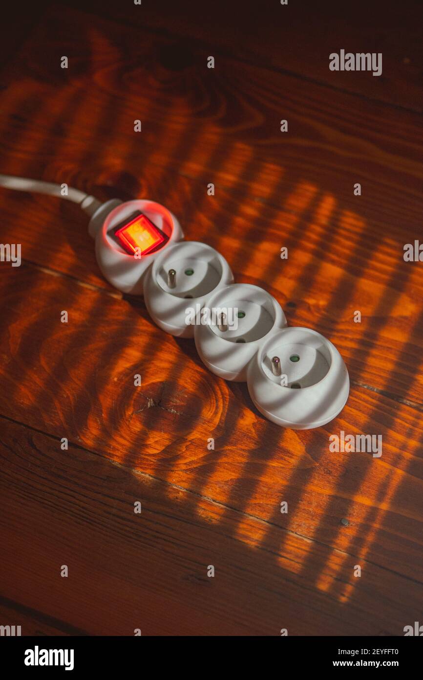 A closeup shot of a power strip on wooden background Stock Photo - Alamy