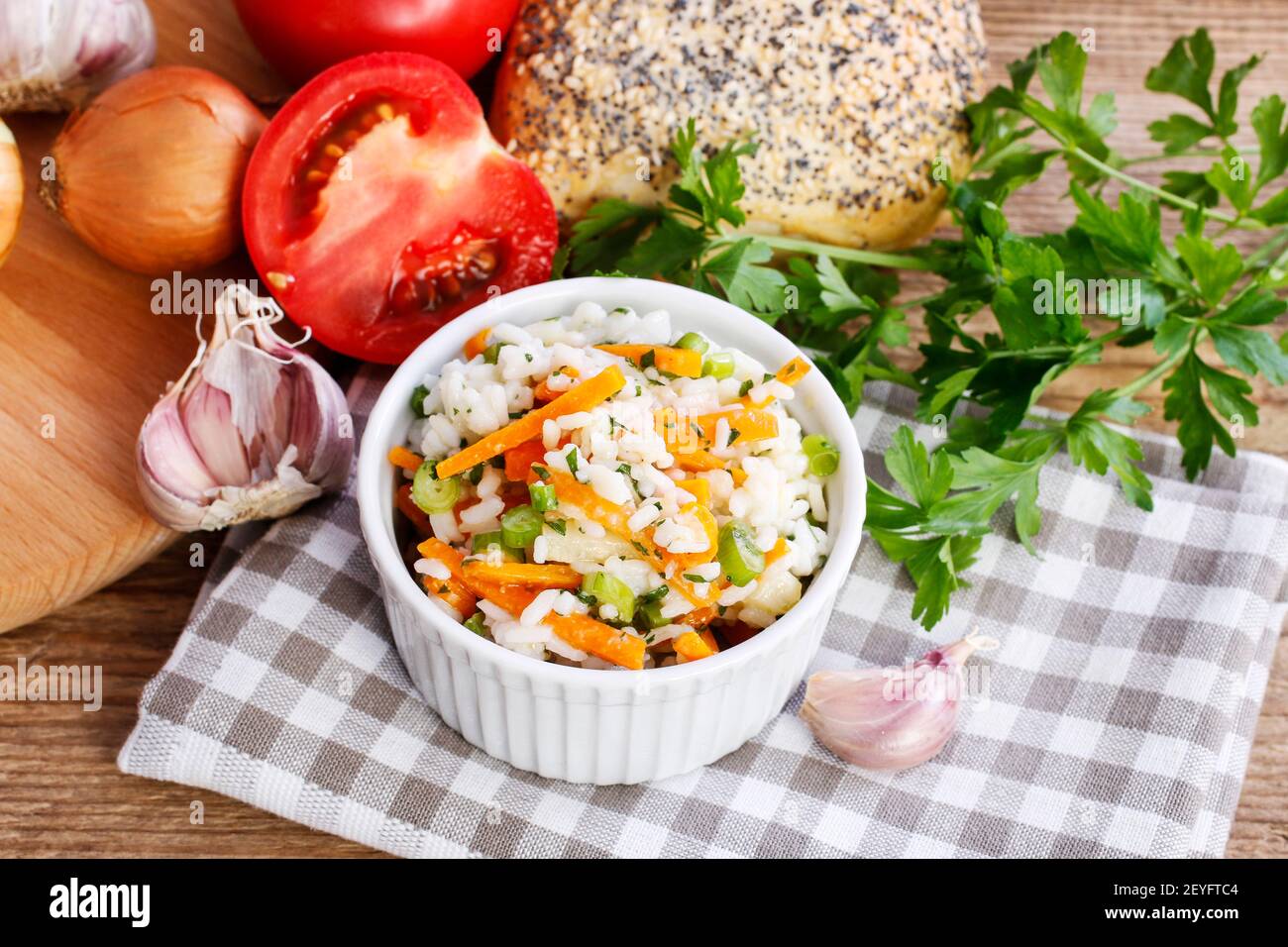 Boiled rice with vegetables in a white ribbed bowl. Lunch time Stock ...