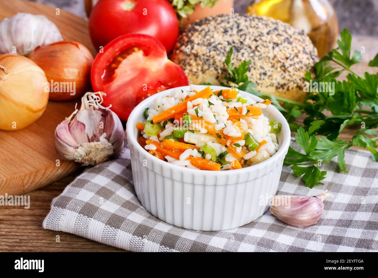 Boiled rice with vegetables in a white ribbed bowl. Lunch time Stock ...