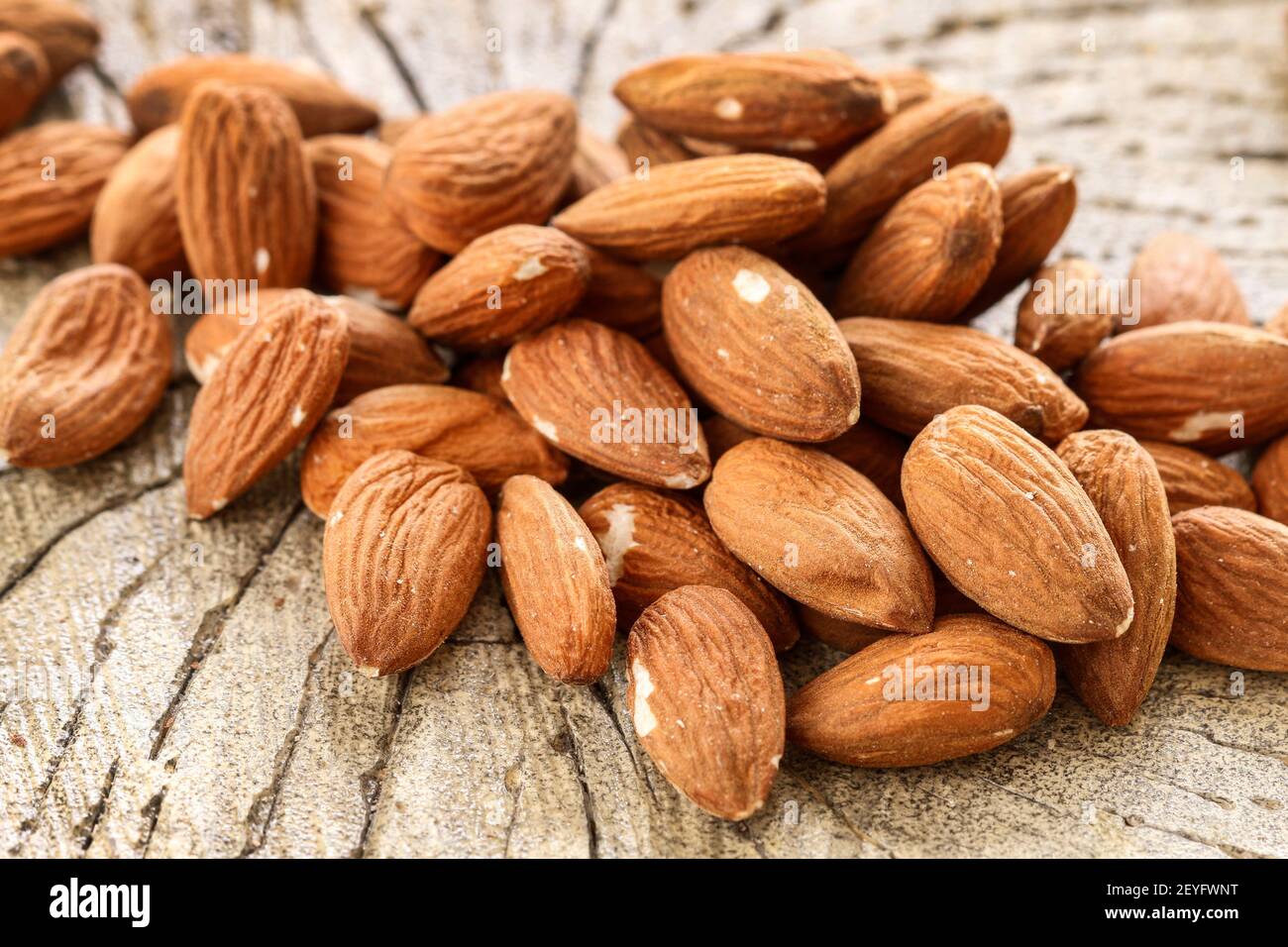 Almonds on rough wooden background, raw fruits. Healthy food Stock ...