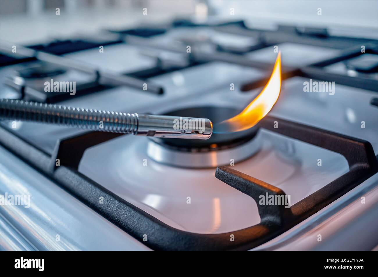 Manual gas lighter gun for cooking with fire. The gas burner is ignited ...