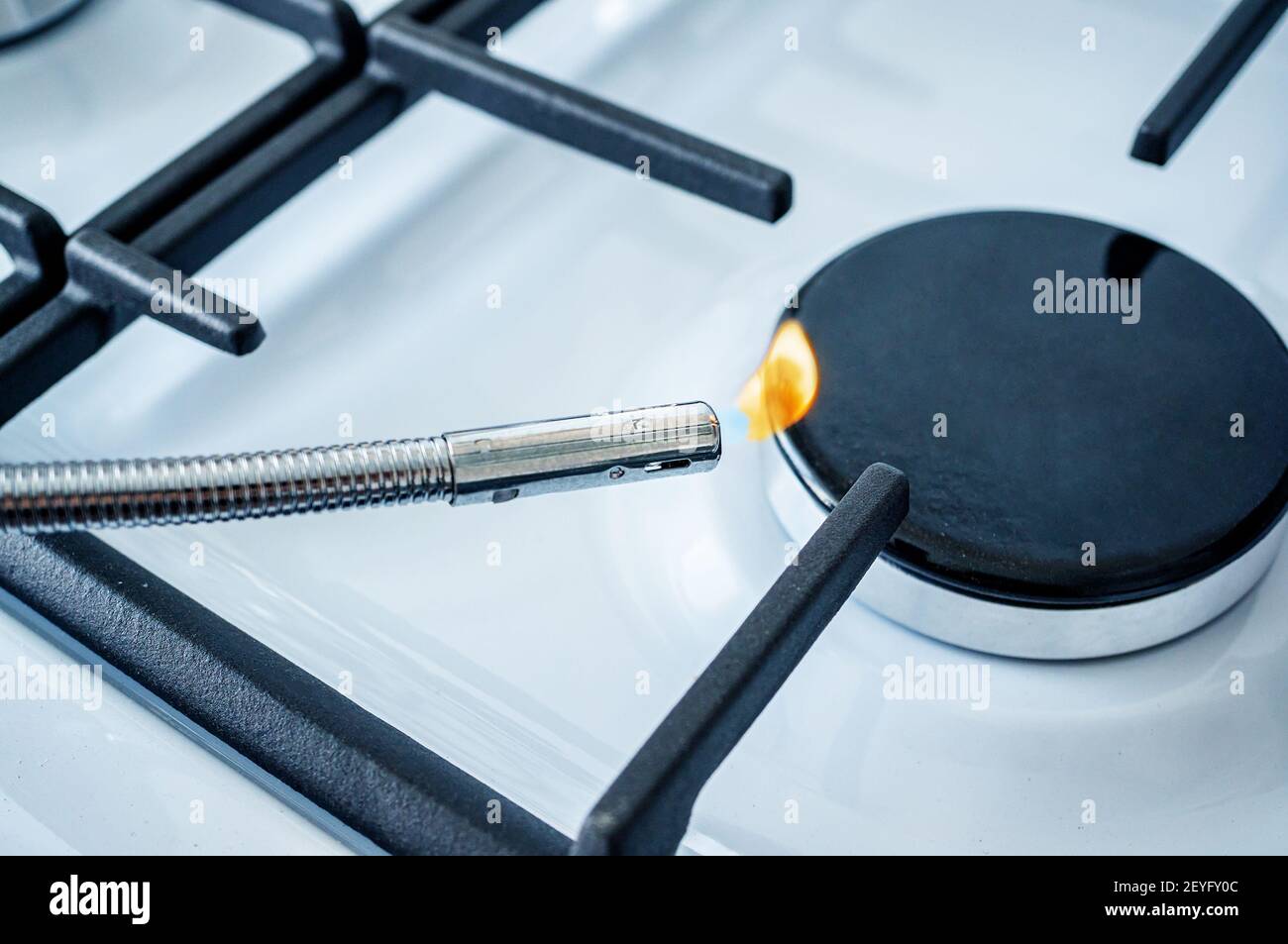 Manual gas lighter gun for cooking with fire. The gas burner is ignited ...